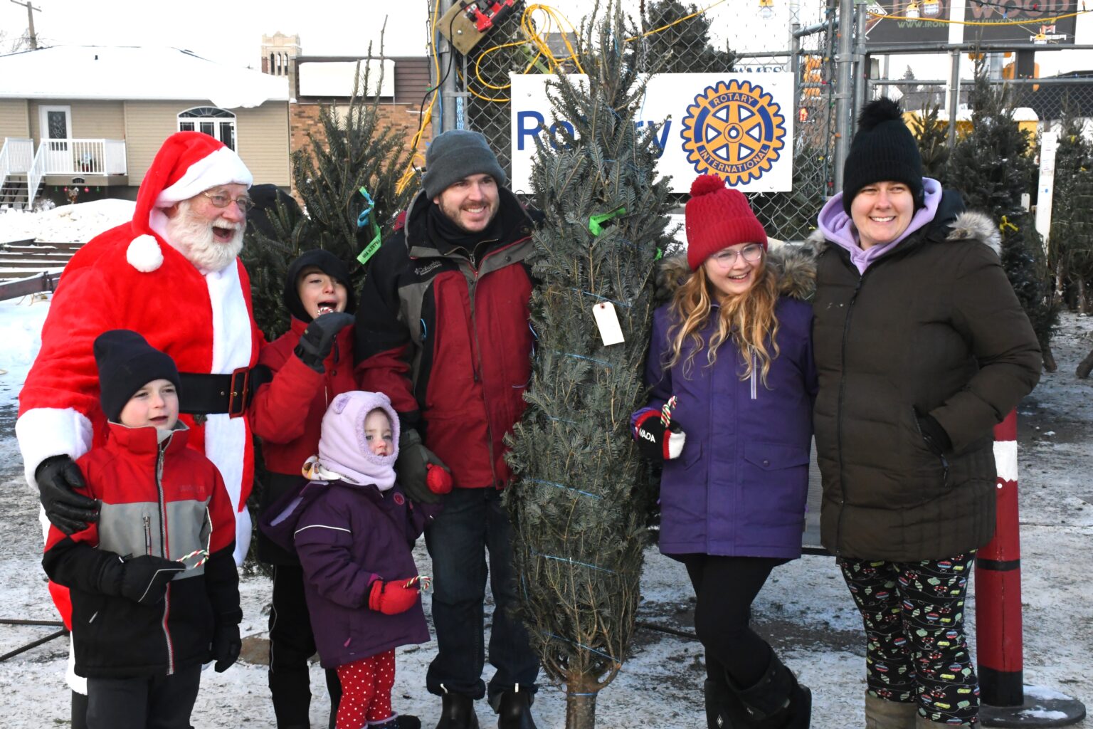 Santa makes a special visit to help families pick a tree with the ...